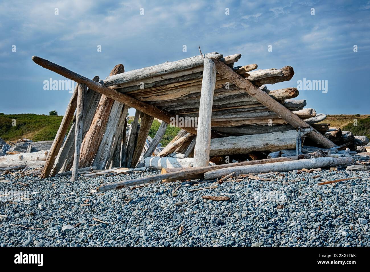 An impressive, large lean-to structure made with large driftwood logs ...
