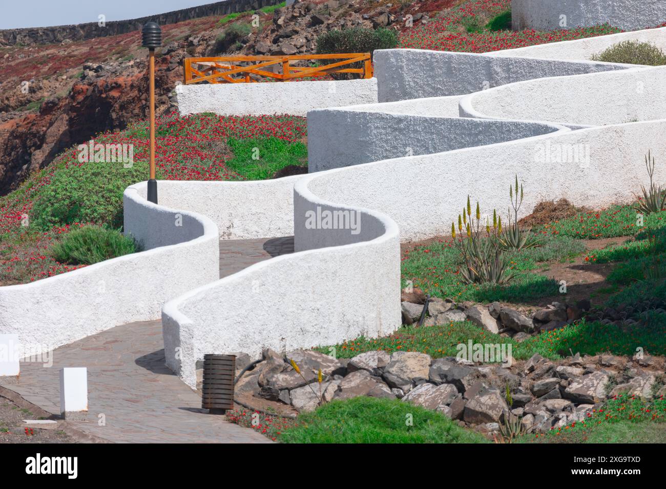 Winding paths retaining walls adorned, leading to ornamental garden on ...
