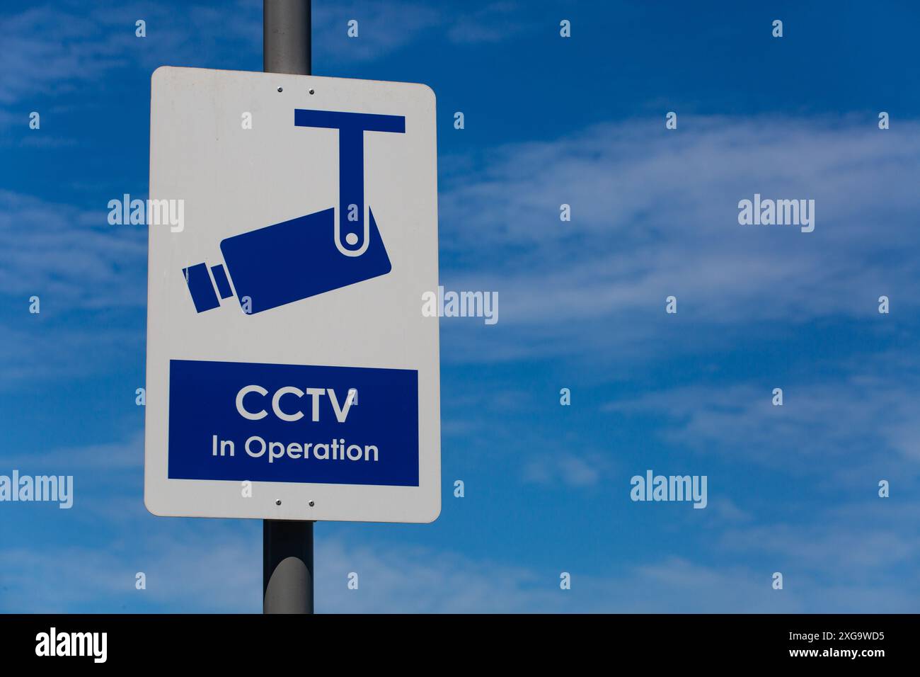 Signboard of CCTV in operation against the blue sky Stock Photo - Alamy