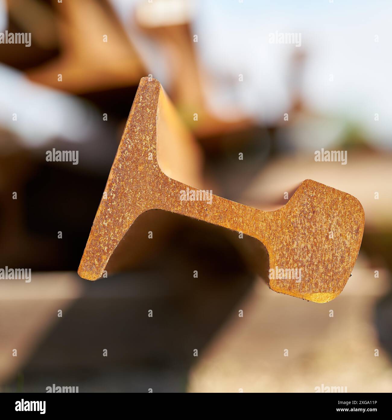 Close-up of the cross-section of a rusty railway track in a storage ...