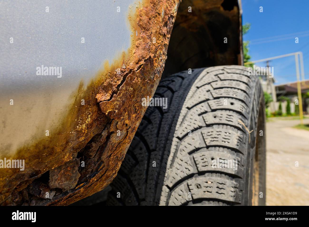 Rusty wheel arches on the car. car corrosion. Background for welding ...
