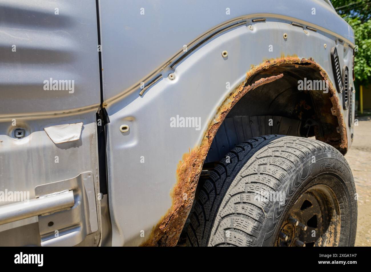Rusty wheel arches on the car. car corrosion. Background for welding ...