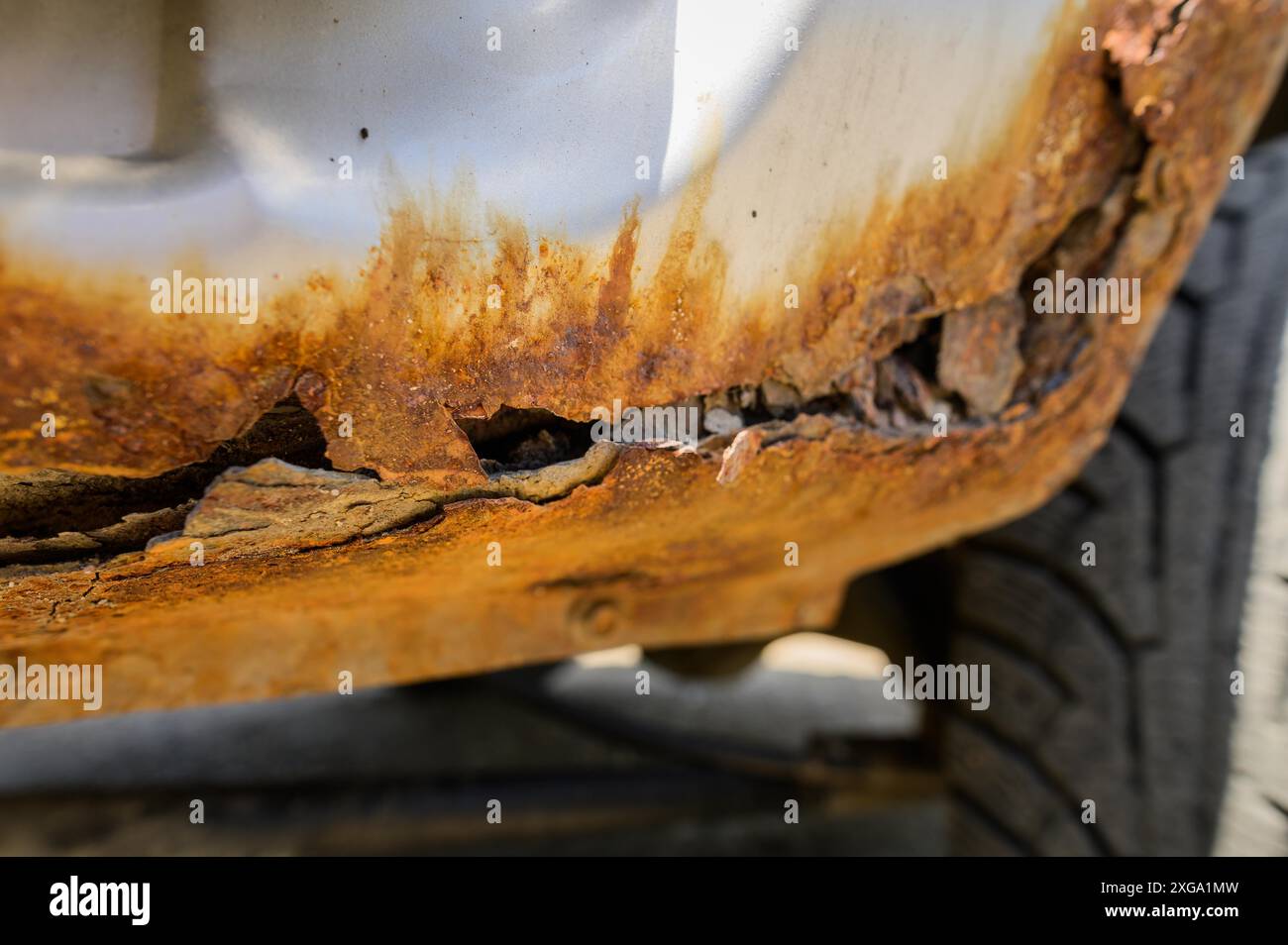 Fragment of a car body with rust. fragment of a rusty wing of a car ...