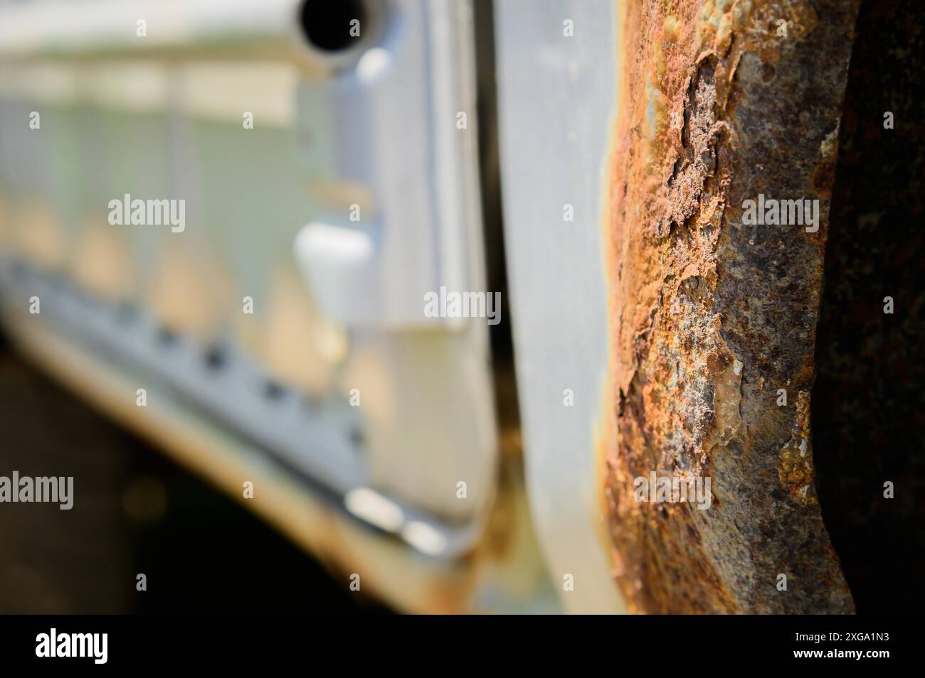 Fragment of a car body with rust. fragment of a rusty wing of a car ...