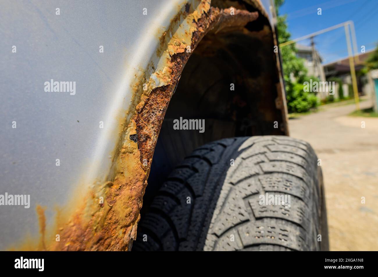 Fragment of a car body with rust. fragment of a rusty wing of a car ...