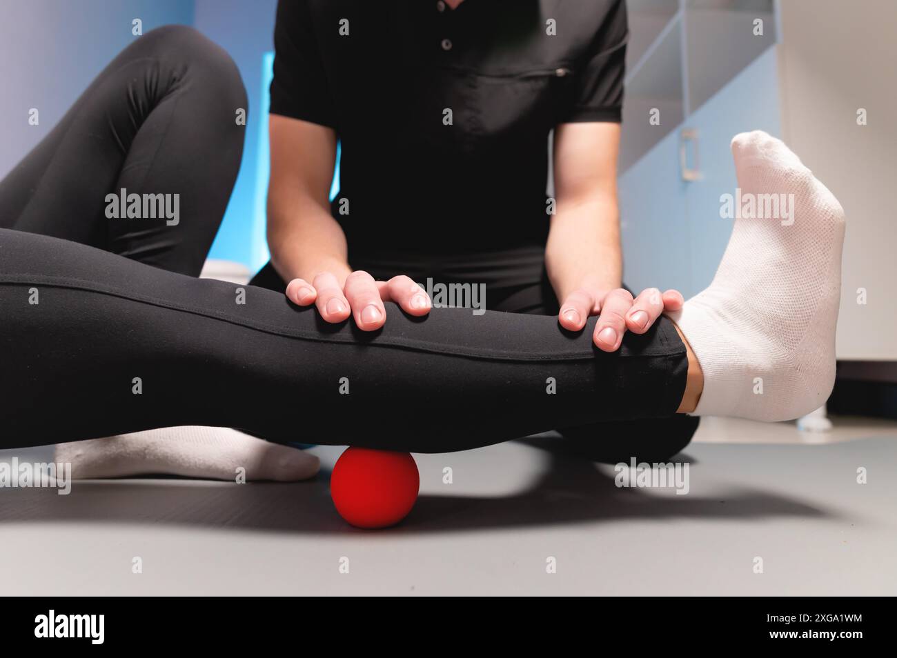 Myofascial release. A male physiotherapist puts a ball to rehabilitate ...