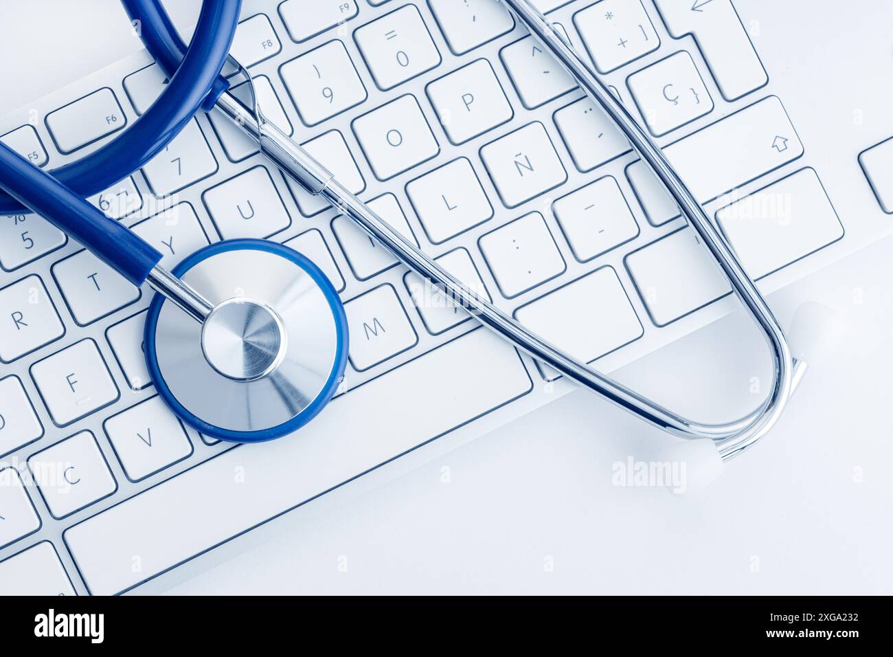 Stethoscope on computer keyboard on white desk. Online health care or ...