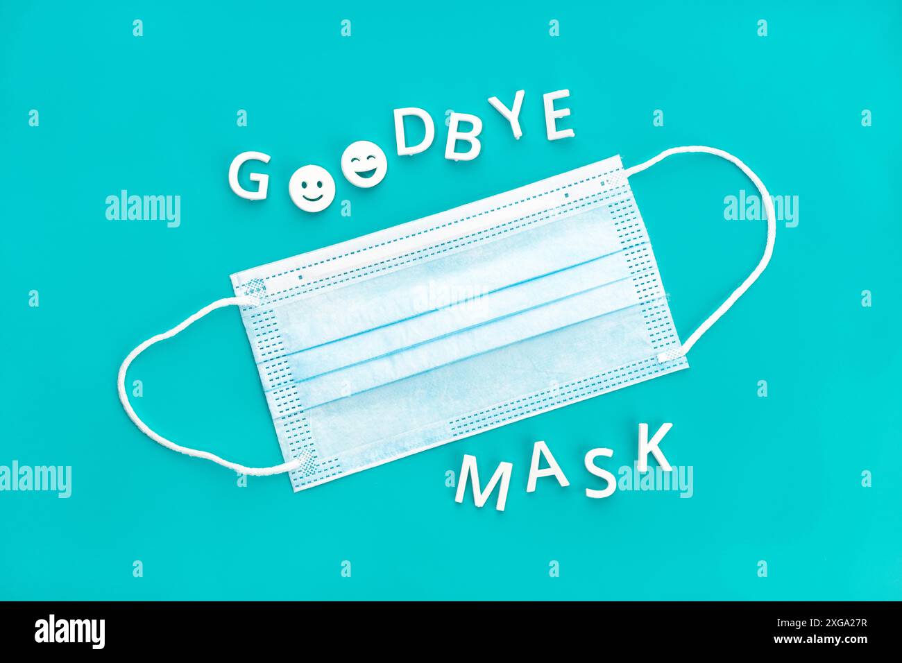 Goodbye mask phrase and face mask isolated on blue background. Concept ...