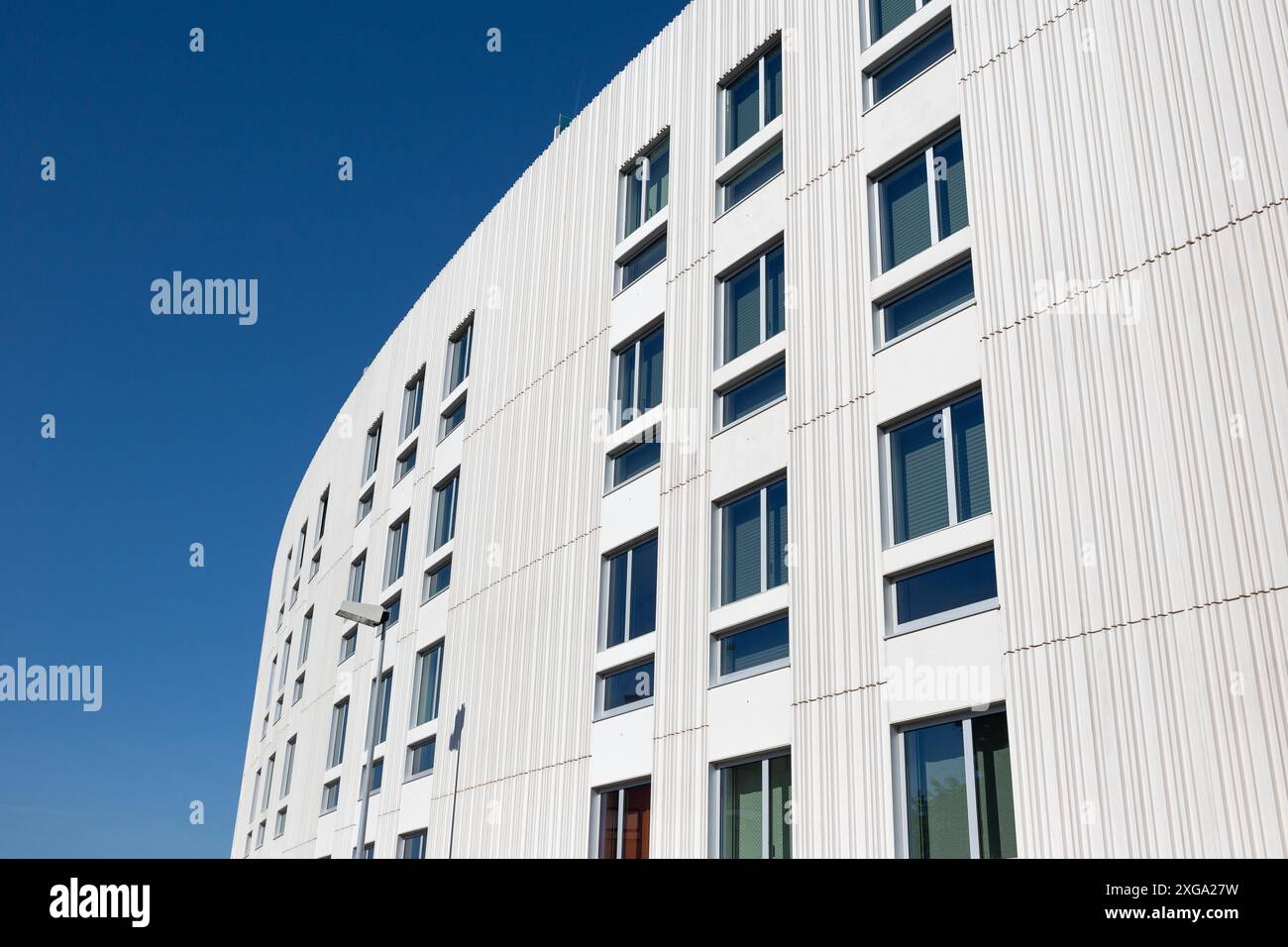 Modern apartment building with decorative grooved concrete facade. Copy ...