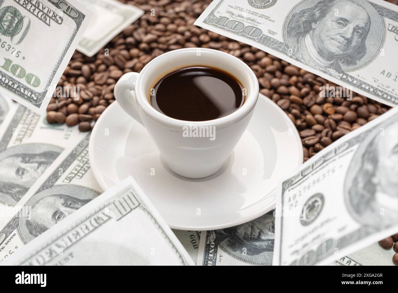 Cup of coffee on Coffee beans and dollar banknotes flying around it ...