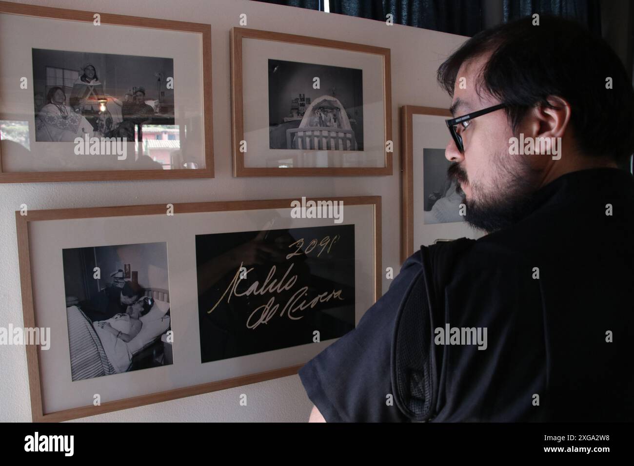 Non Exclusive: A man looks photos of Frida Kahlo during a media tour ...