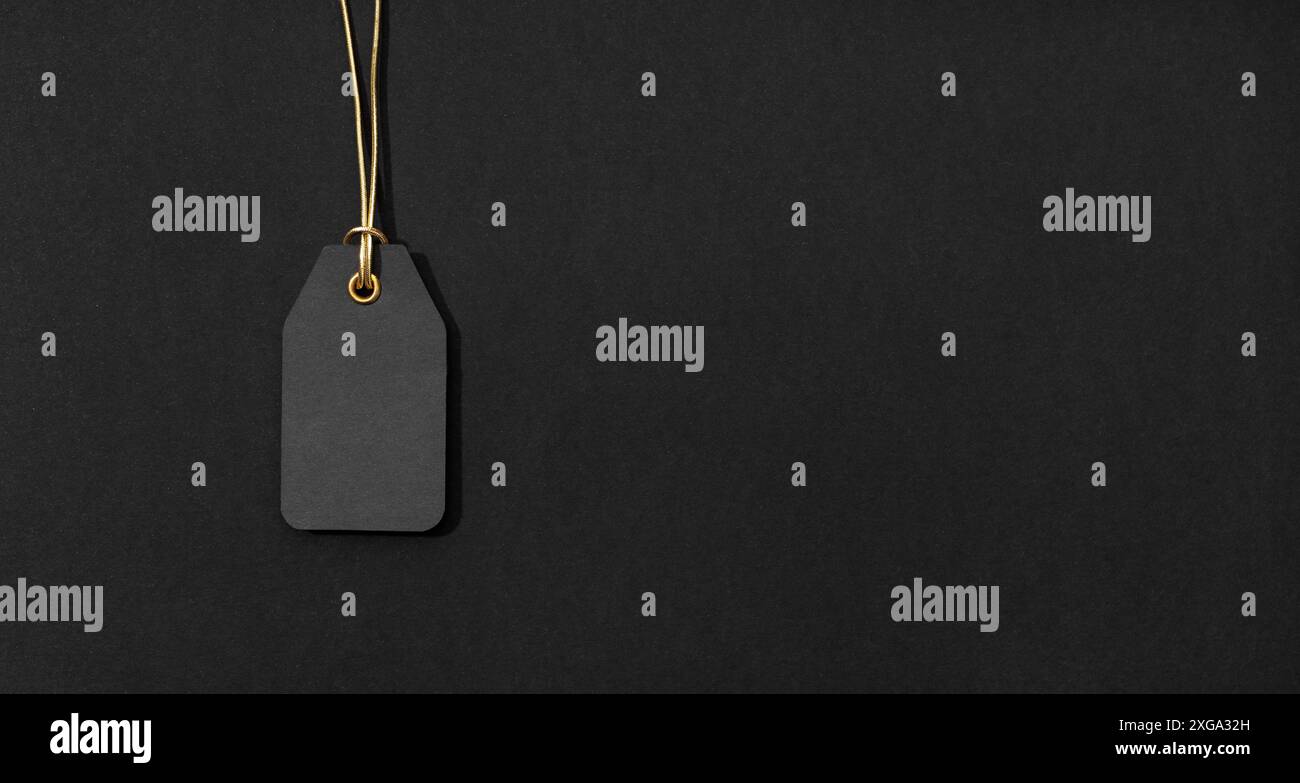 Blank black tag isolated on black background with copy space. Template ...