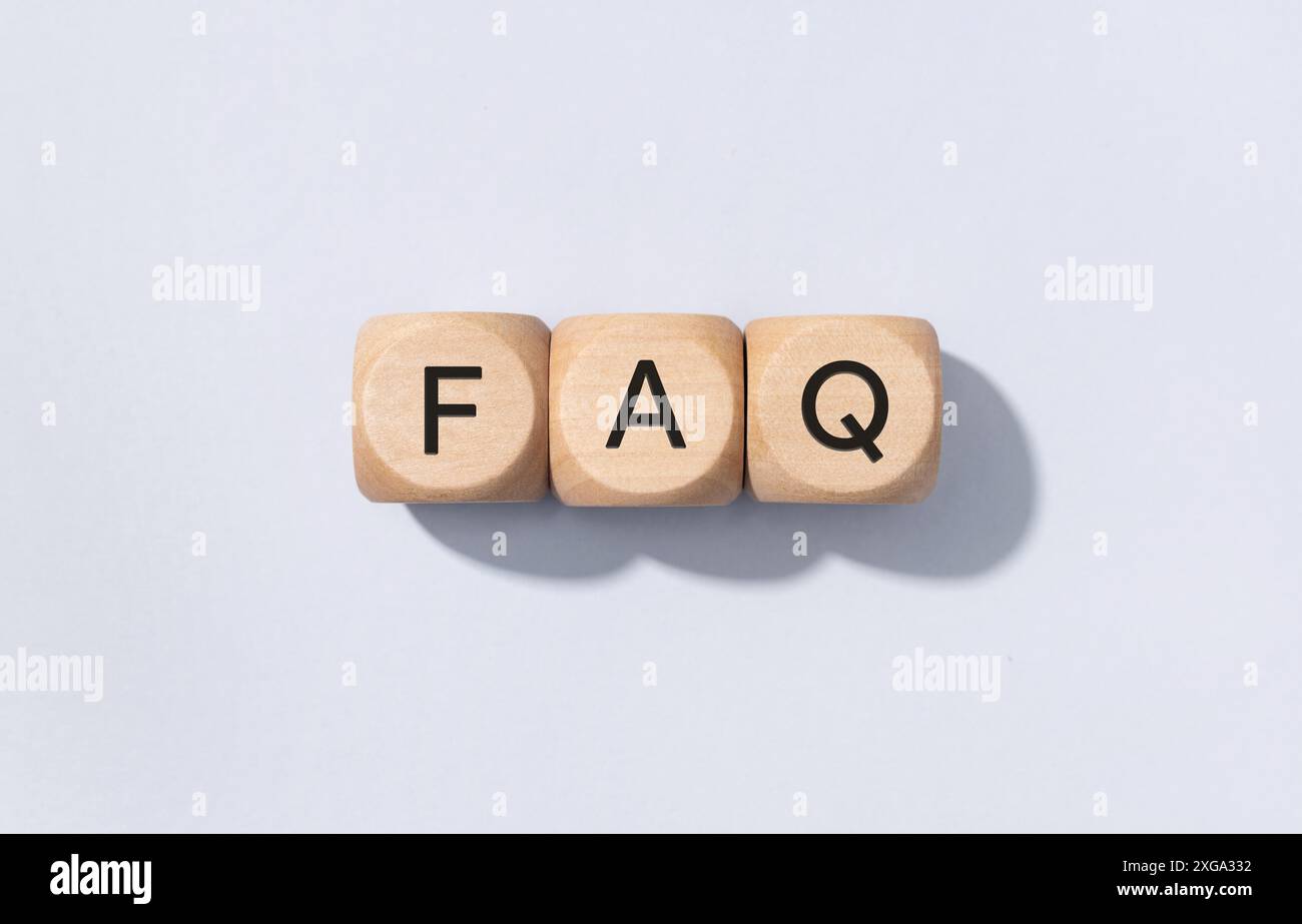 FAQ or Frequently Asked Questions concept. Text on Wooden cube blocks ...