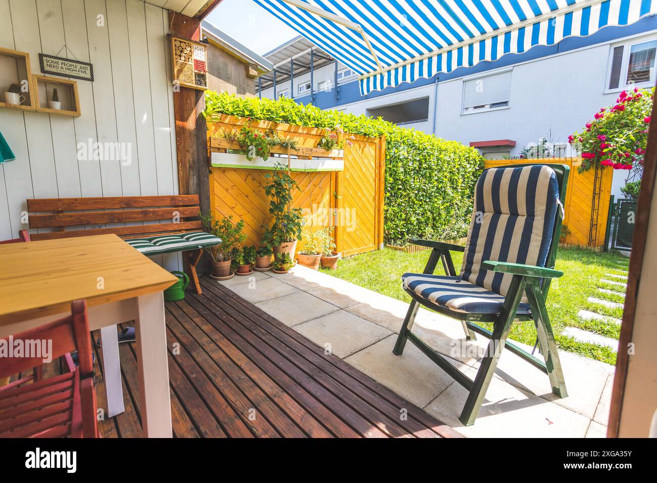 Cozy veranda with little green garden, summer time Stock Photo - Alamy