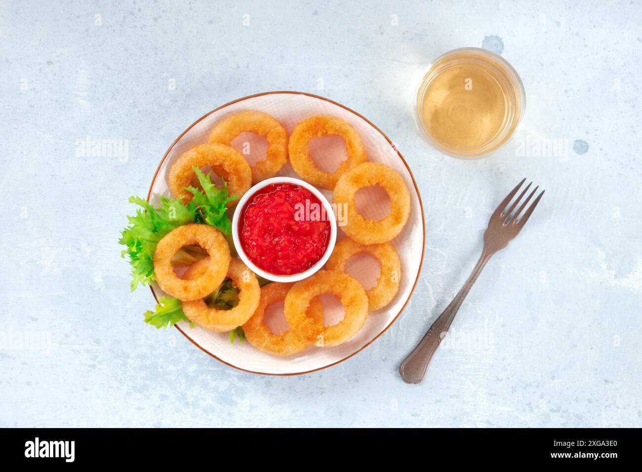 Calamari rings. Deep fried squid rings with a dip, salad, and a glass ...