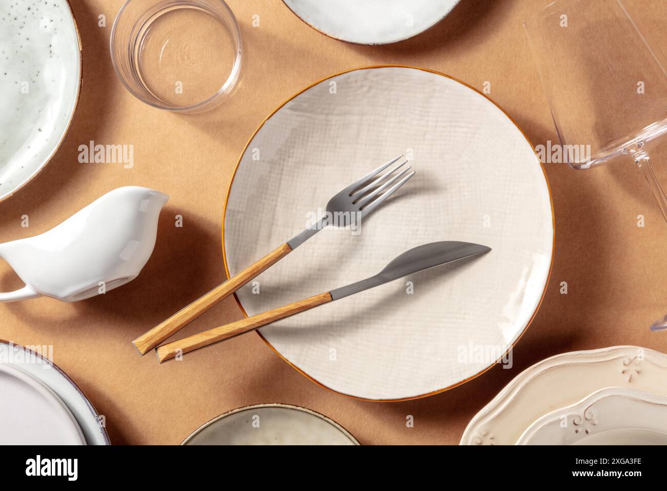 Modern tableware, overhead flat lay shot. Trendy plates, glasses, and ...