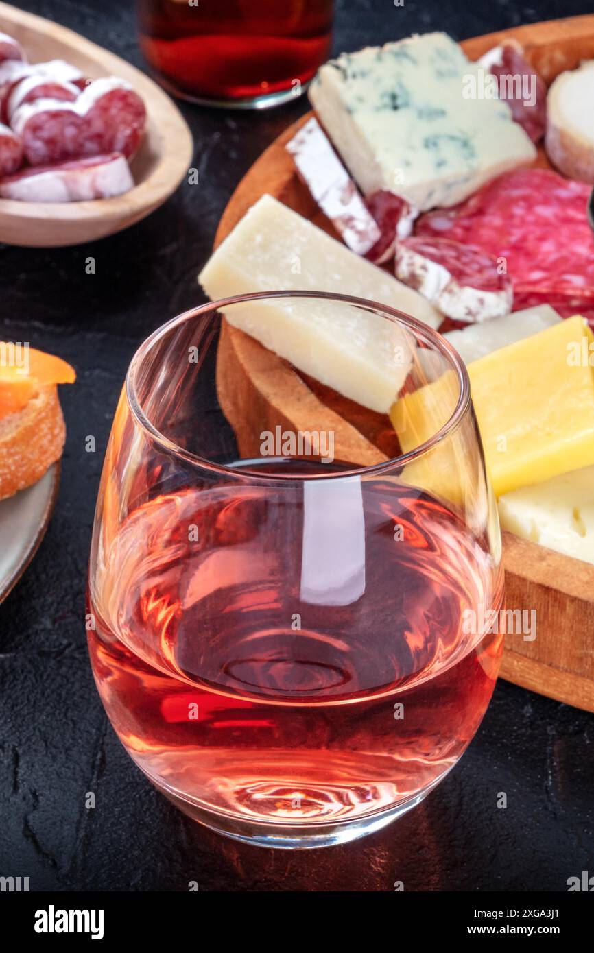 Rose wine with ham and cheese. Spanish tapas in a bar. Food sharing ...