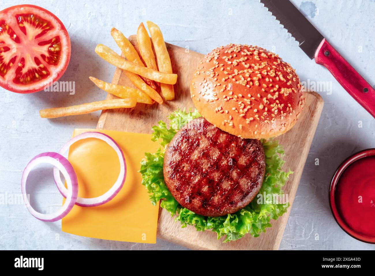 Burger ingredients, overhead flat lay shot with French fries and a ...