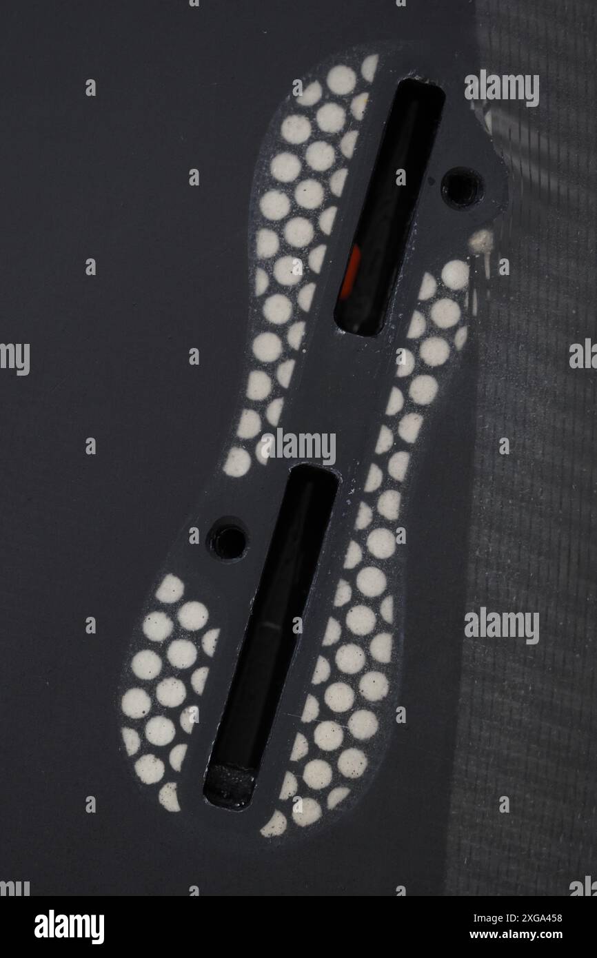 Fin box on black surfboard. Close-up Stock Photo - Alamy