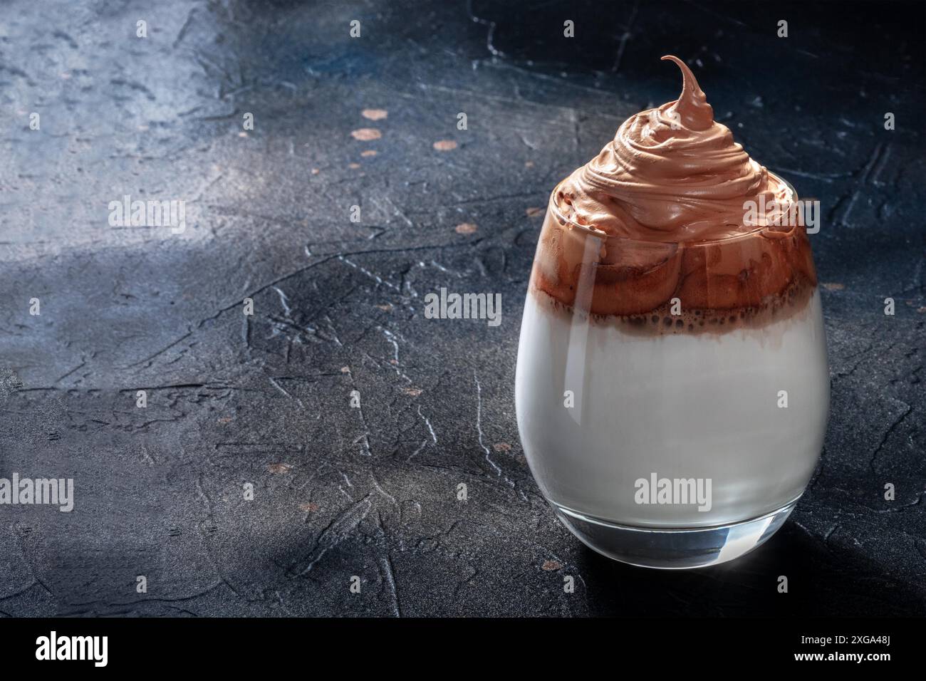 Dalgona cold coffee. Frothy Korean drink with cream on a black ...