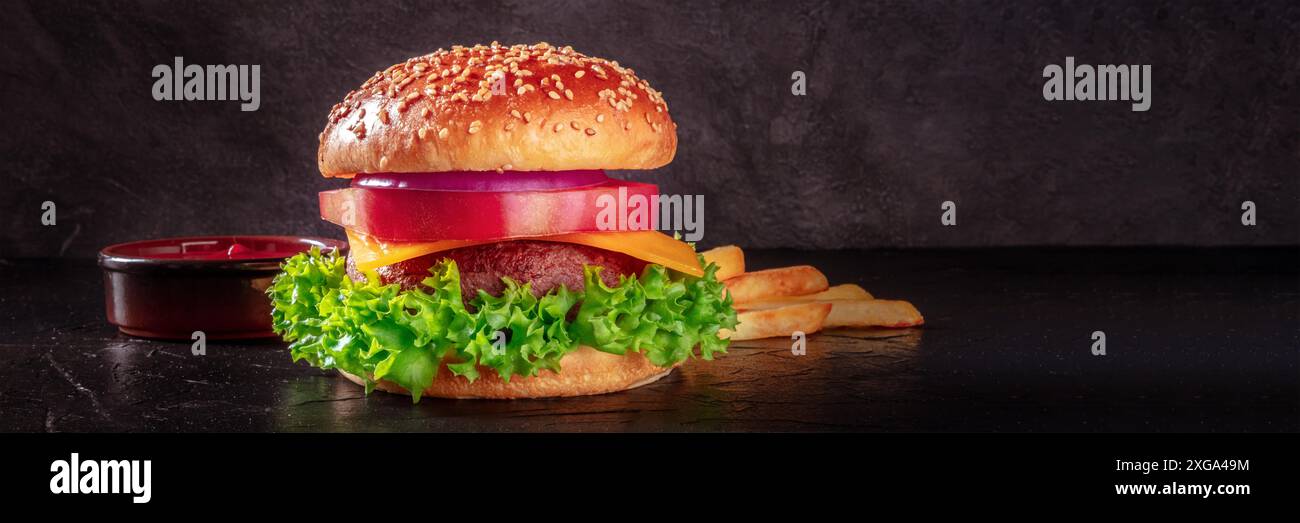 Burger panorama on a black background with copy space. Beef patty steak ...