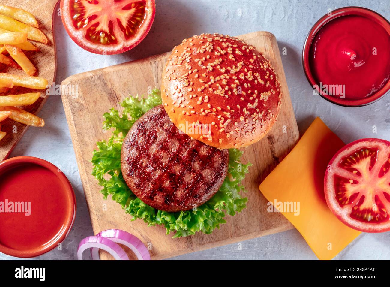 Beef burger ingredients, overhead flat lay shot with French fries ...