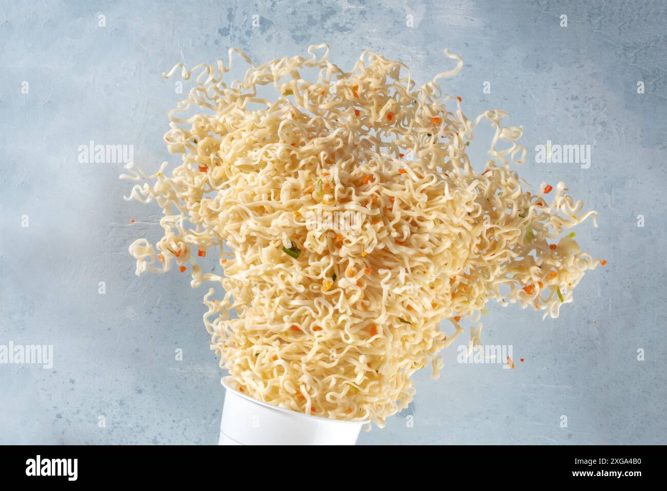 Instant noodles flying out of a plastic ramen cup, noodle tornado Stock ...