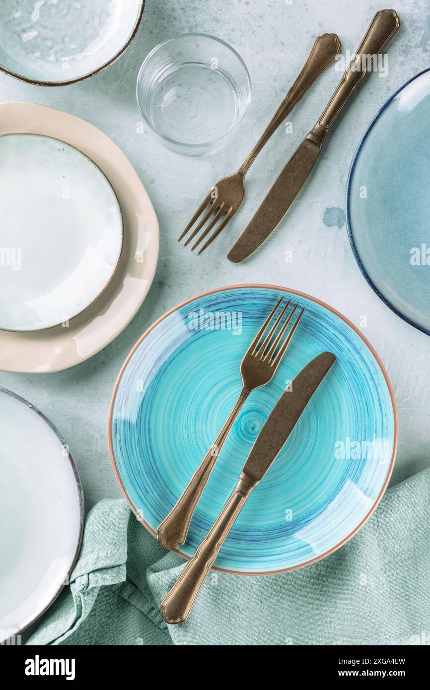 Modern dinnerware with cutlery and various plates, overhead flat lay ...