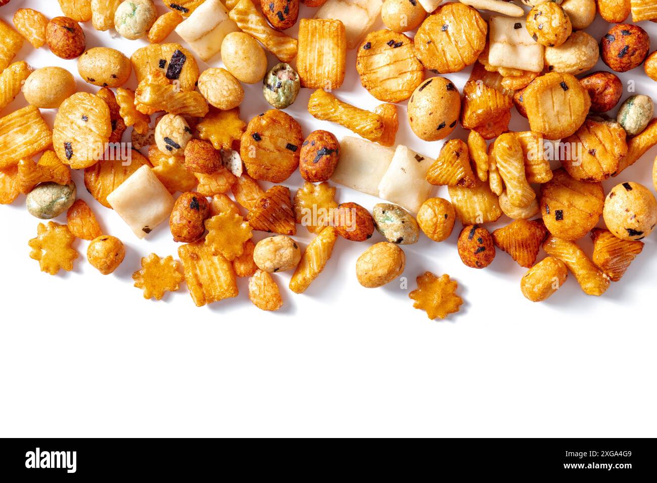 Japanese rice crackers, scattered on a white background, overhead flat ...