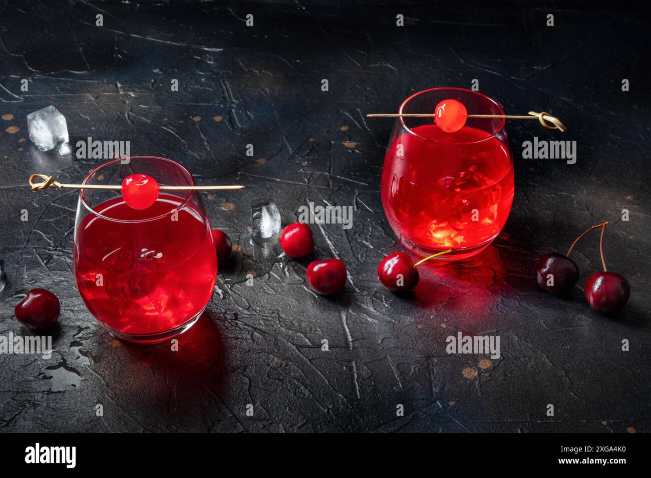 Cocktail cherry and a mocktail on a dark background, a vibrant red ...