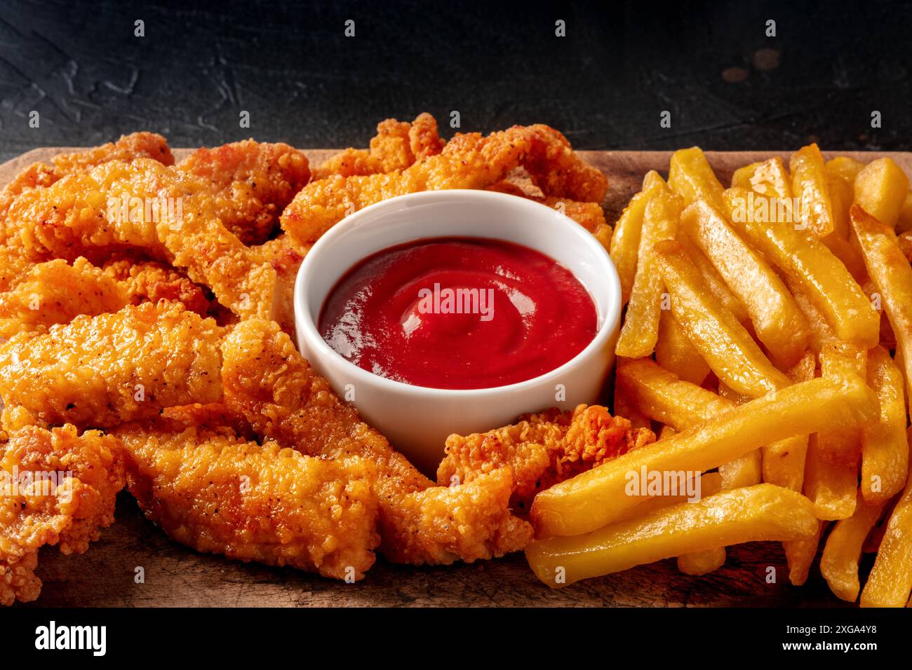 Chicken tenders, crispy boneless meat pieces with a red dip and French ...