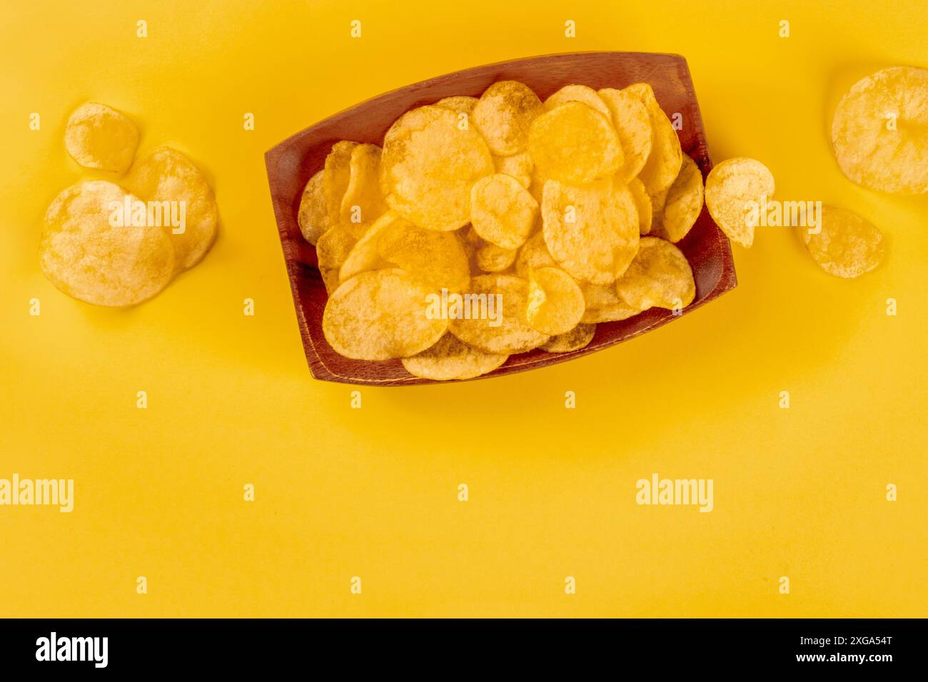 Potato chips or crisps, a salty snack in a bowl, shot from above on a ...