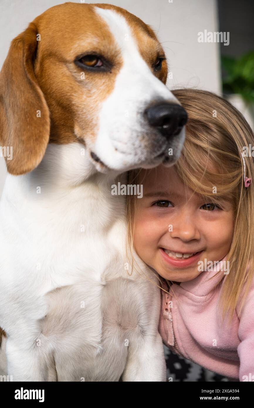 2 year old child hugging best friend dog. Happy childhood with pet ...