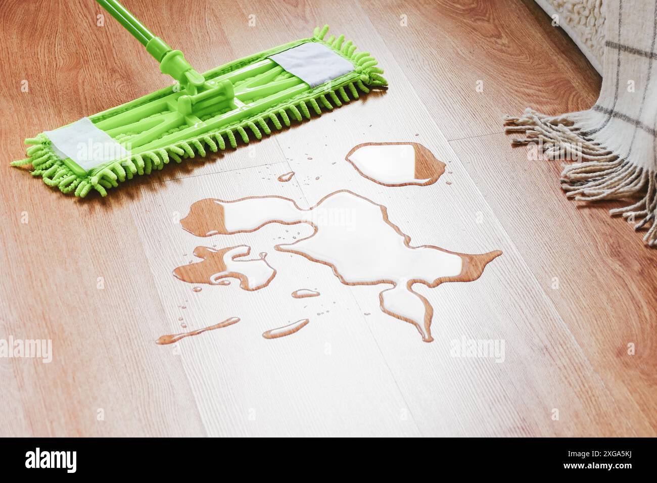 Wiping water on the floor in the bedroom with a mop Stock Photo - Alamy