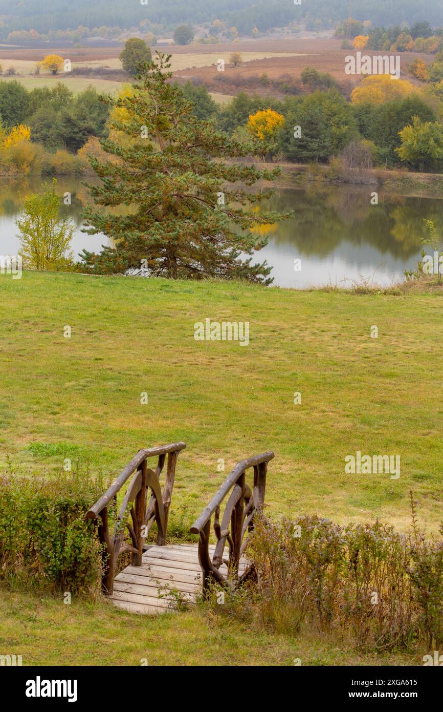 Autumn landscape with lake, trees and small bridge Stock Photo - Alamy