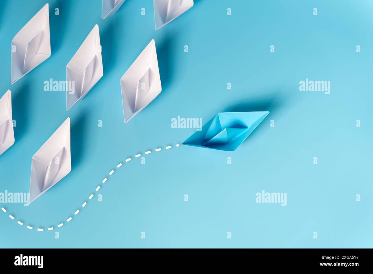 Leadership concept using blue paper ship among white. Leadership ...