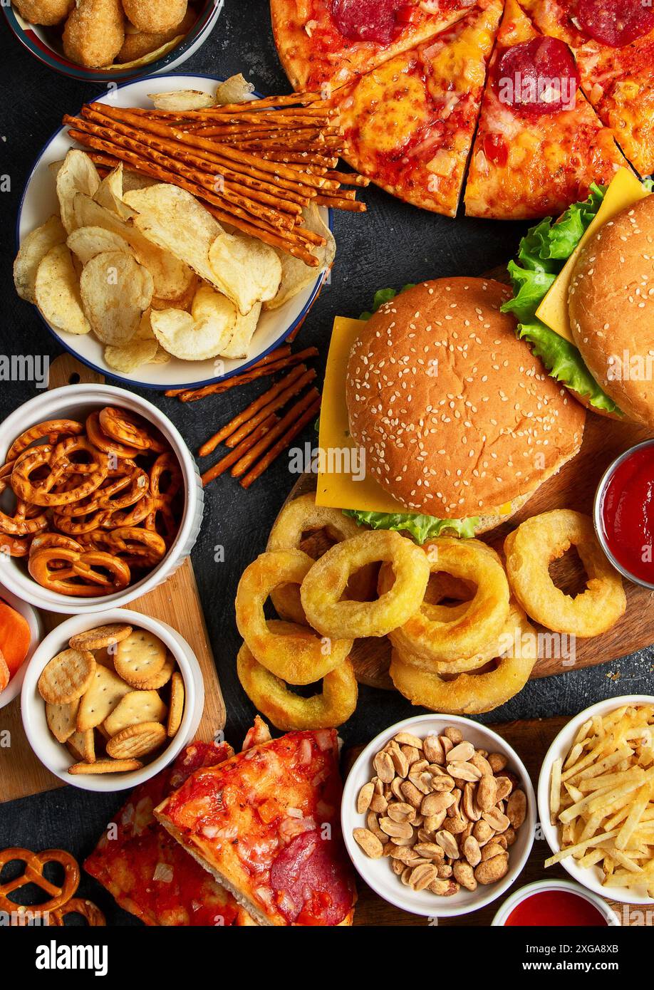 Large table of assorted take out food such as pizza, french fries ...