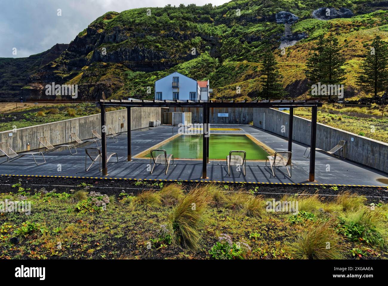 Thermal pool in the middle of nature, surrounded by mountains and a ...