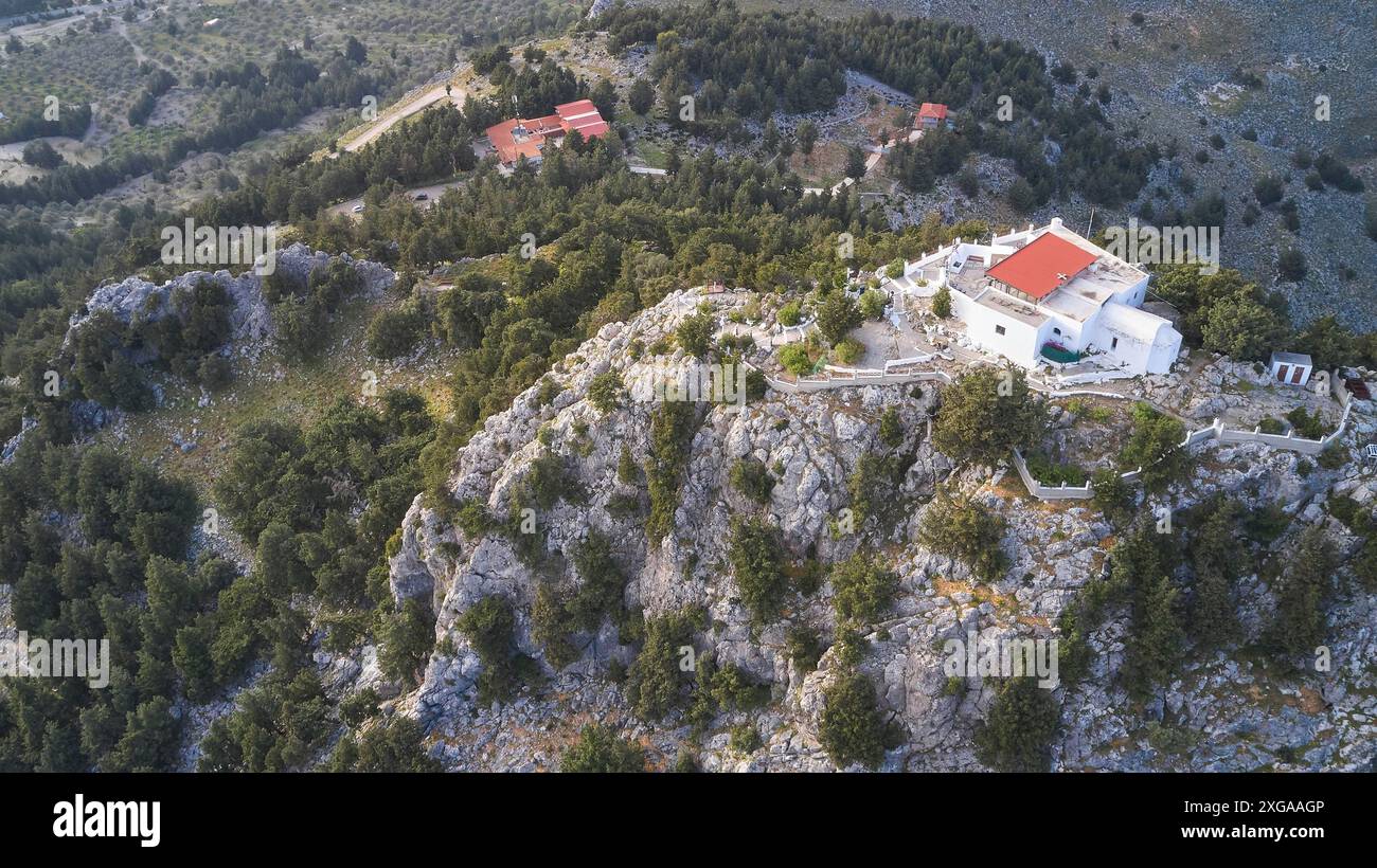Drone shot, A building on a rocky hill, surrounded by wooded nature and ...