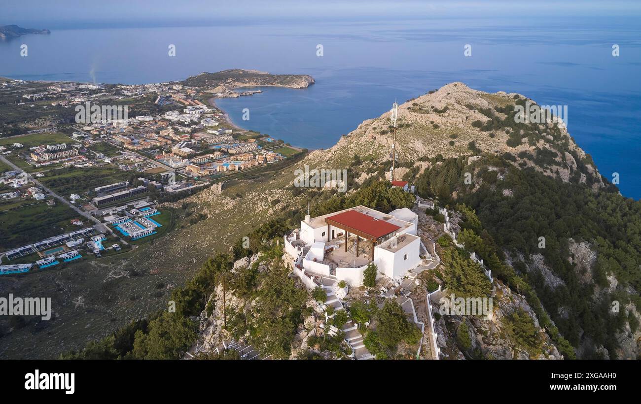 Drone shot, A white building on a hill with sea view over a coastal ...