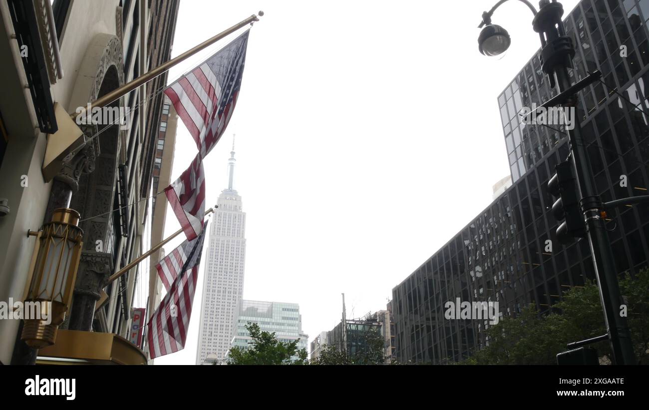 New York, american flag waving. Empire State Building. Manhattan ...