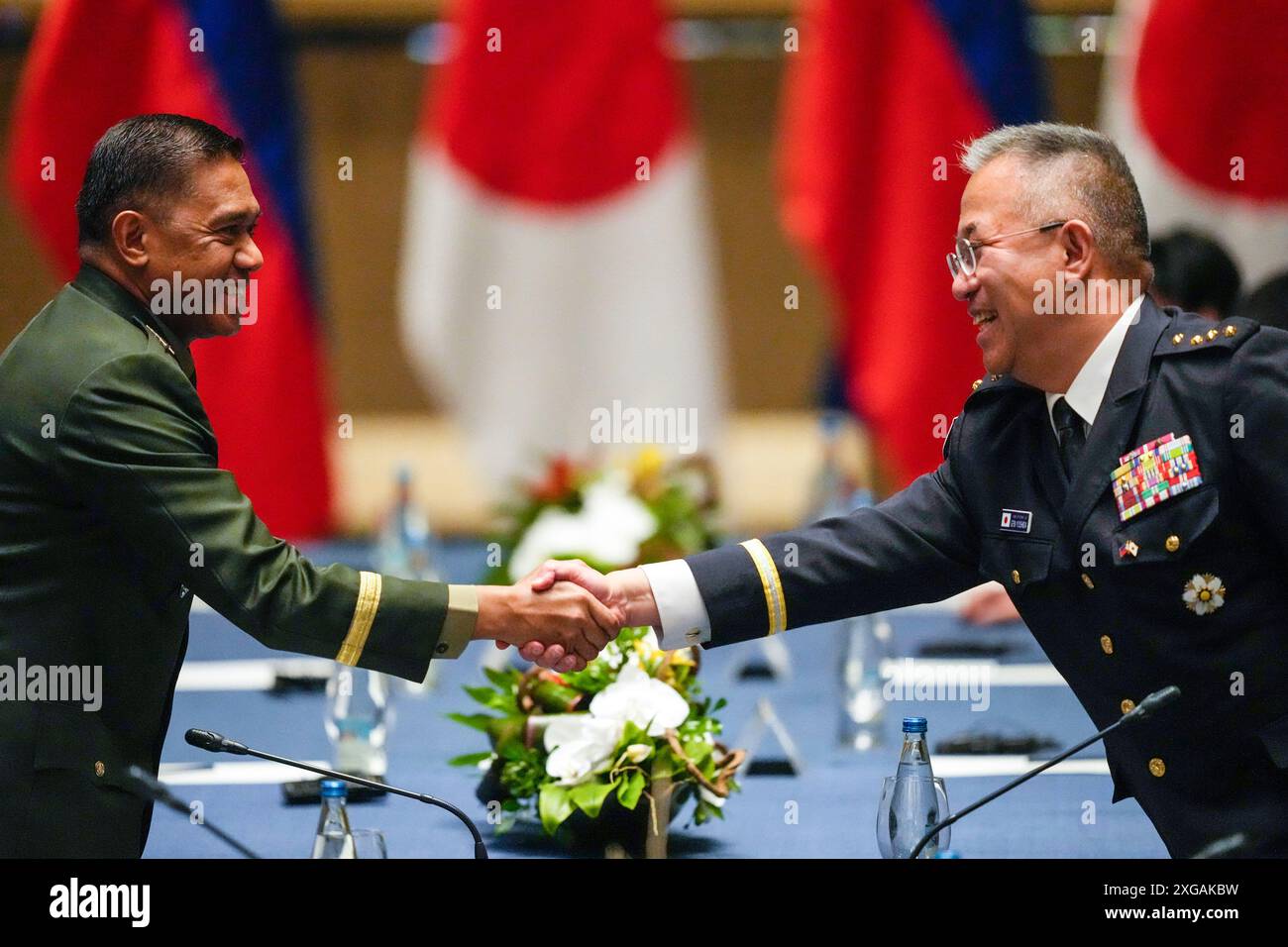 Philippine military chief Gen. Romeo Brawner Jr., left, shakes hands ...