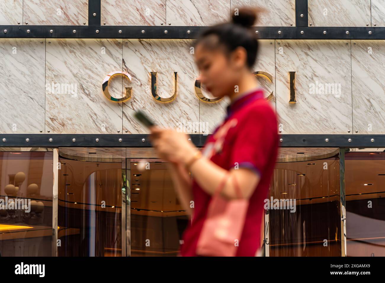 Chongqing, China - 08 May 2024: Shoppers walking past the Gucci store ...