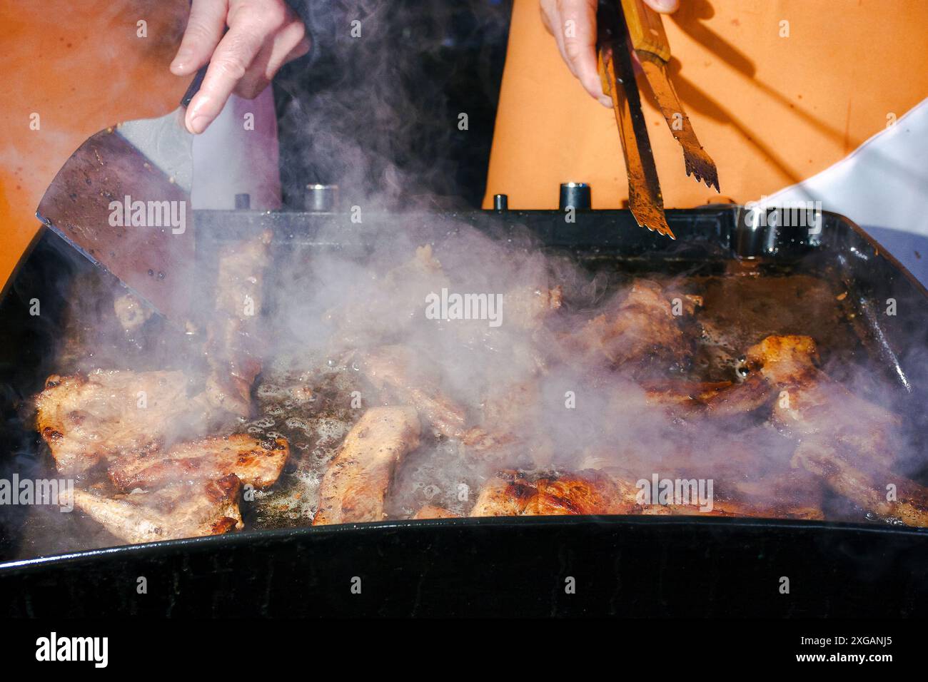 process of meat frying in boiling oil. outdoor food cooking background ...