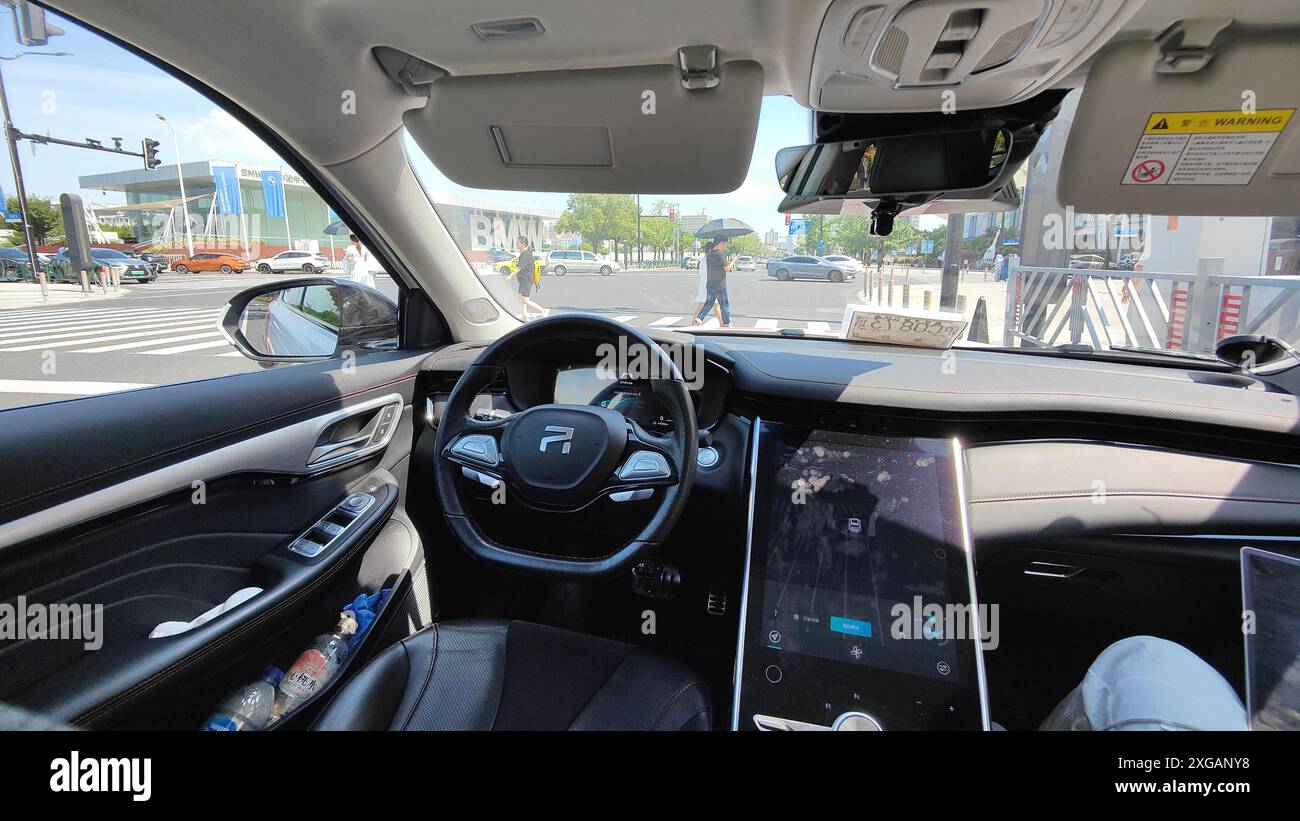 SHANGHAI, CHINA - JULY 7, 2024 - People test a driverless taxi at the ...