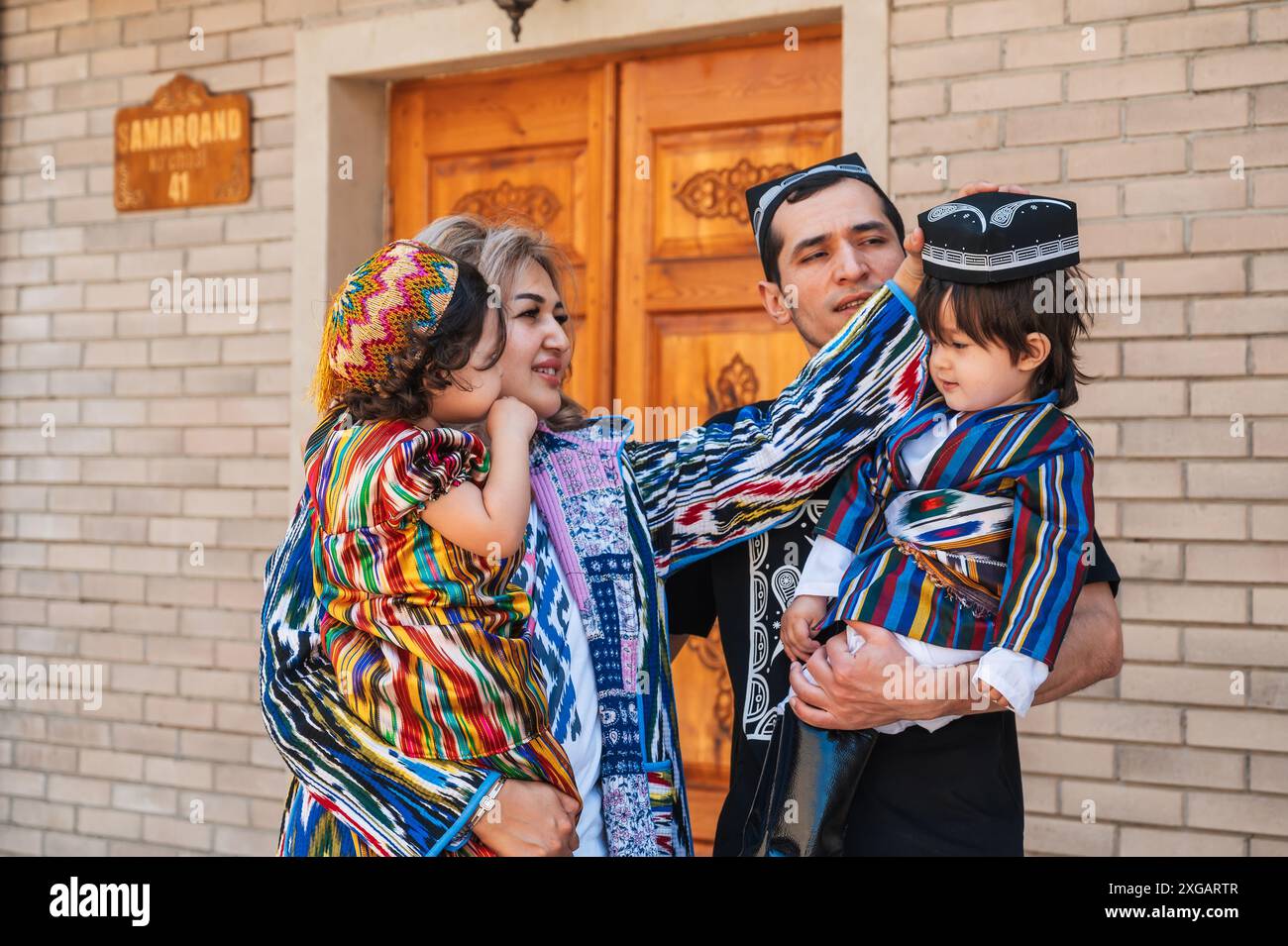 Happy Uzbek family with children in traditional Uzbek costumes on the ...