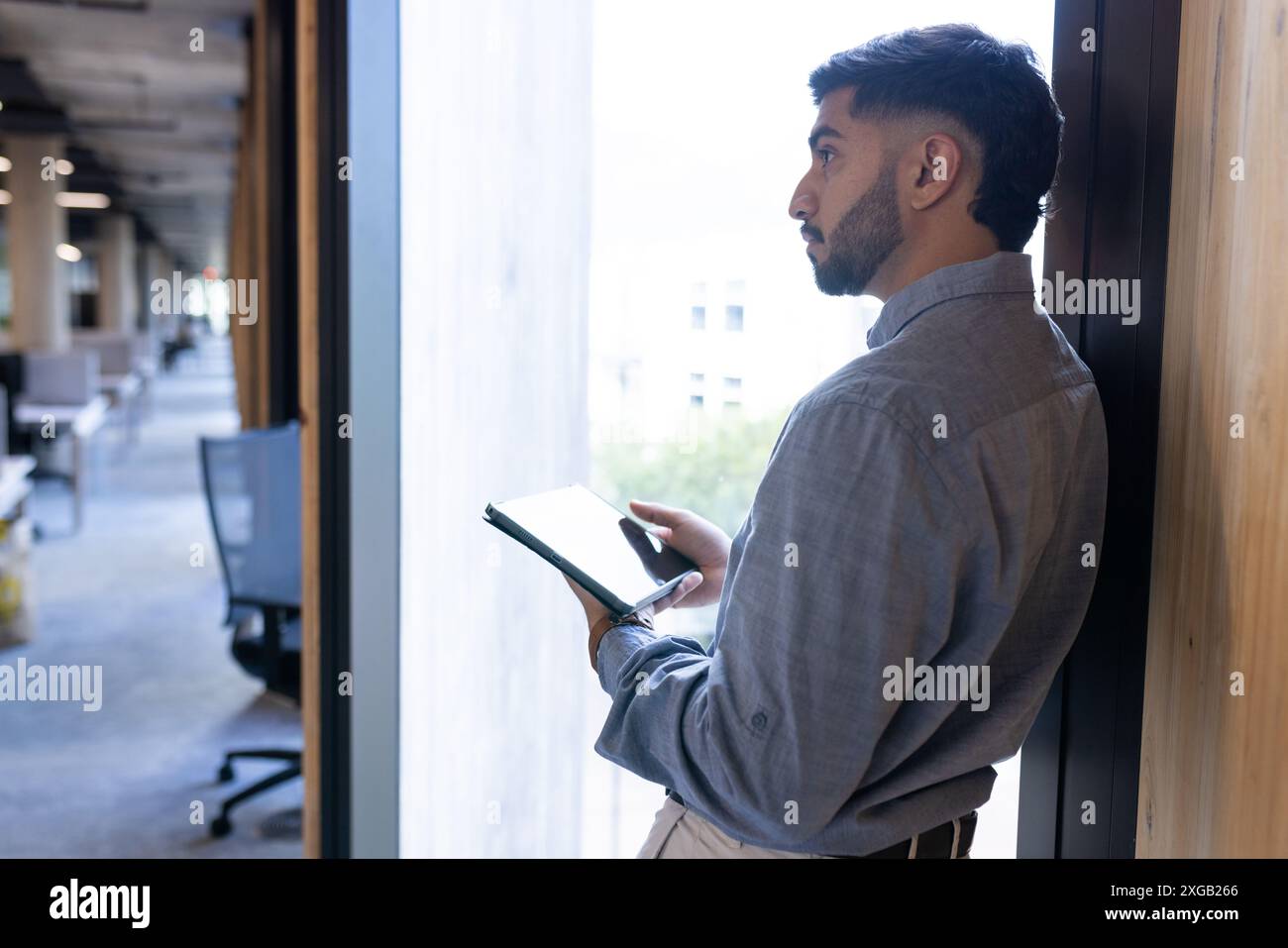 Business man standing window hi-res stock photography and images - Alamy