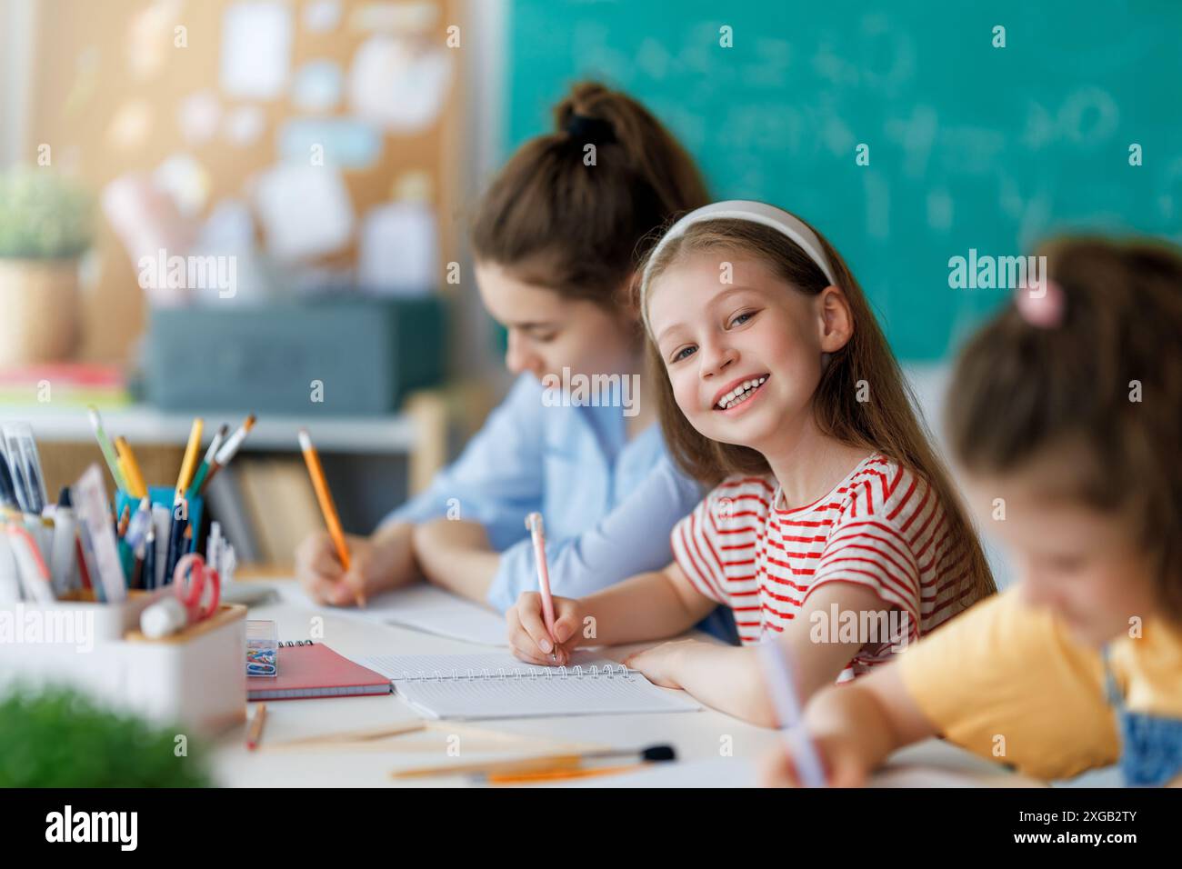 Happy kids at school. Children are learning in the class Stock Photo ...
