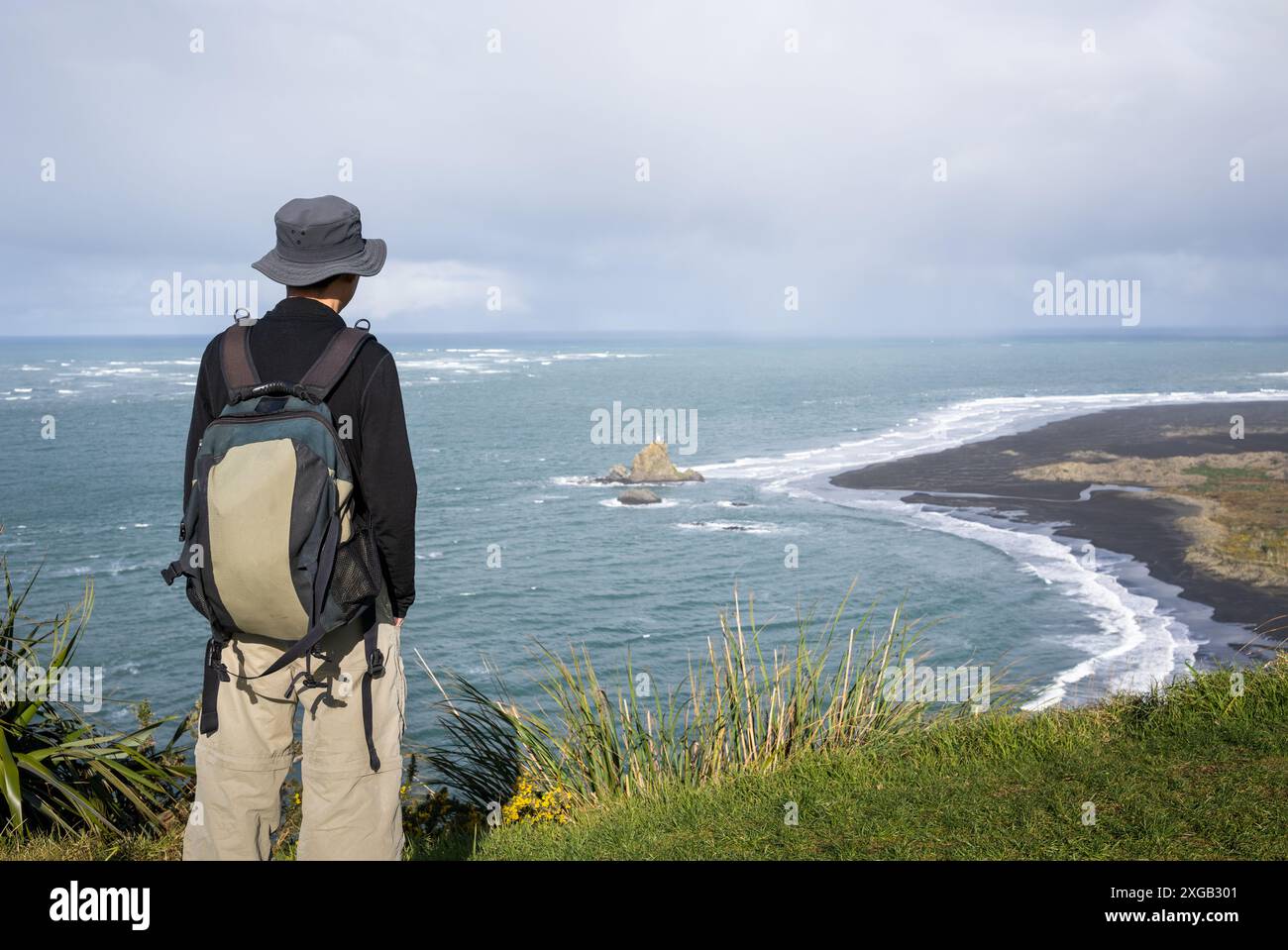 Man looking at the views of Whatipu Beach. Omanawanui track. Waitakere ...