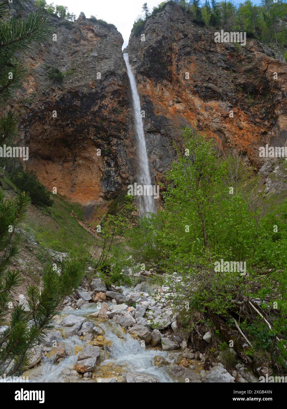 The picturesque waterfall Rinka falls from a steep ledge. Slovenia ...